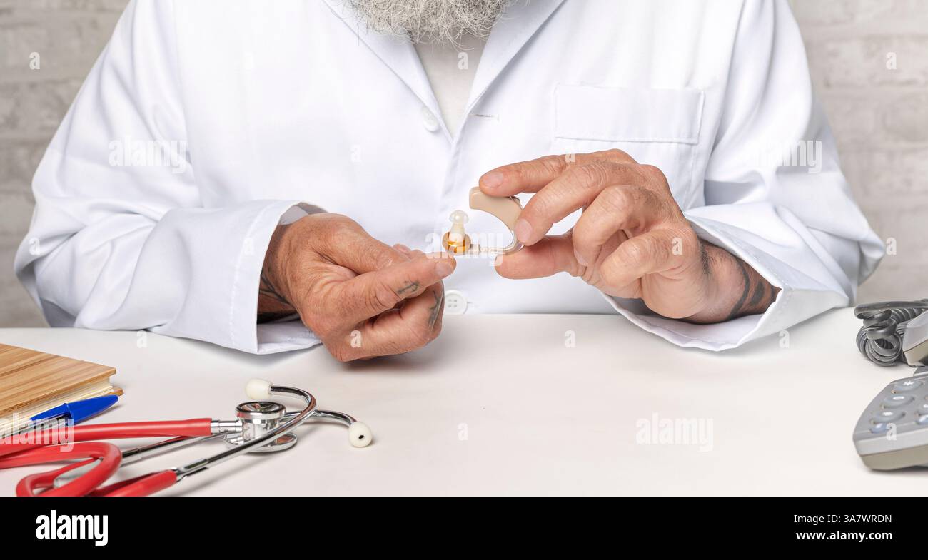 Orthodontic doctor showing hearing aid device for deaf patient Stock ...