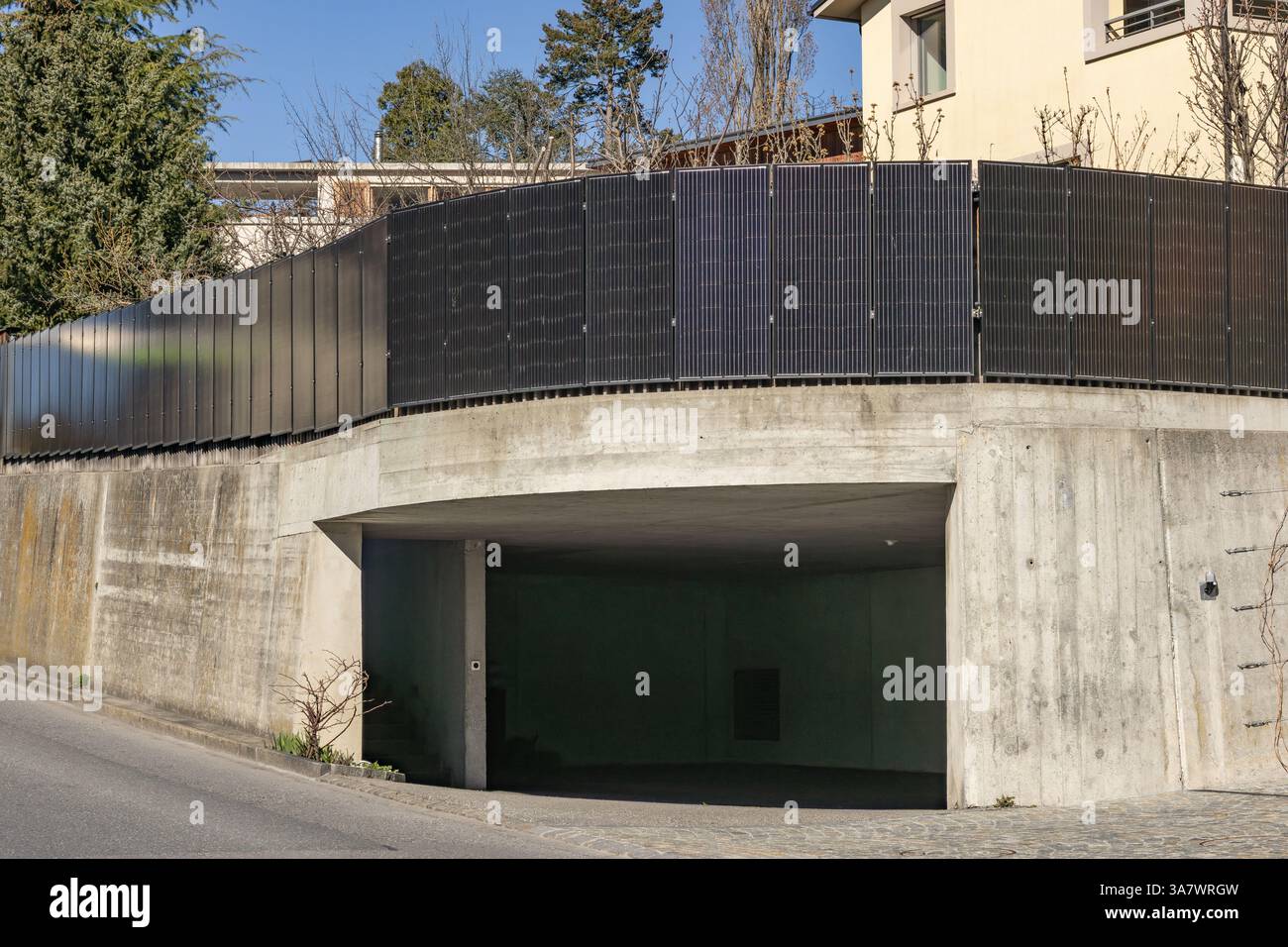 solar fence on the concrete garage of a residential complex Stock Photo ...
