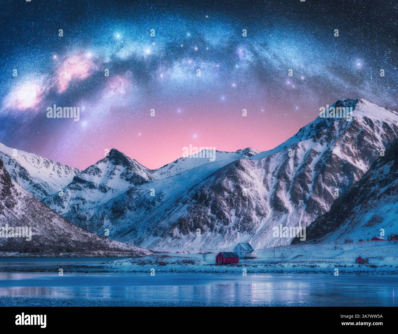 Milky Way arch above fjord and snowy mountains on starry winter night ...