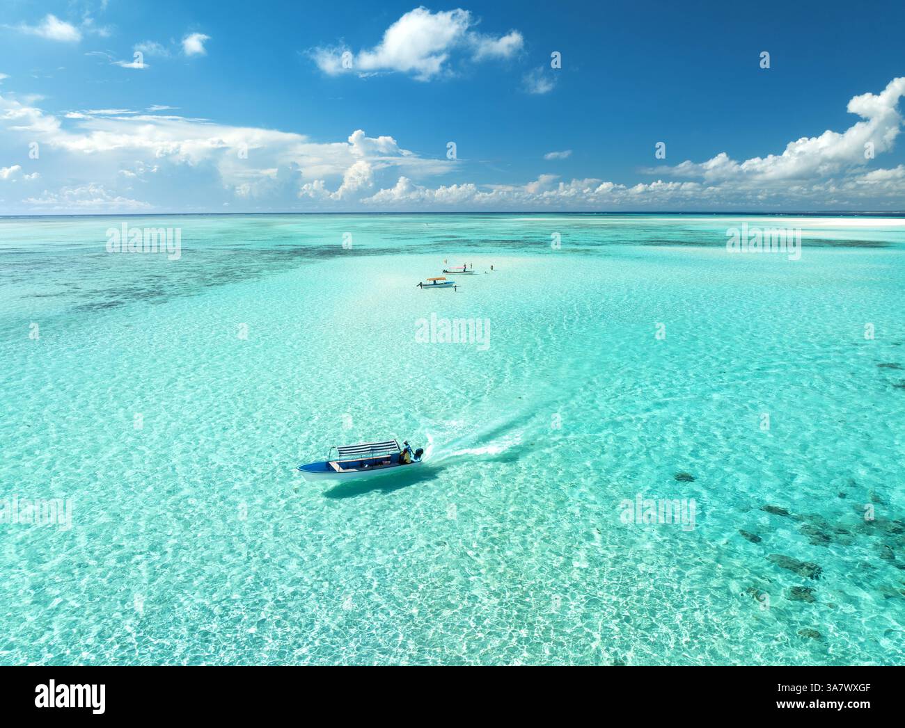 Aerial view of colorful boats in clear azure water in summer. Mnemba ...