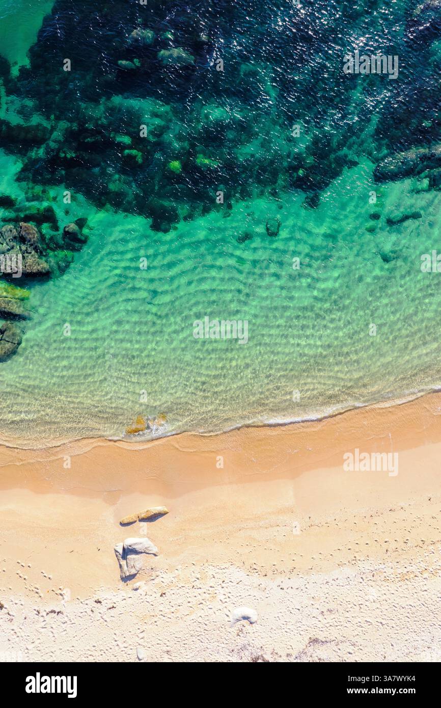 drone photography of sand and rocks at the water's edge. Aerial drone ...