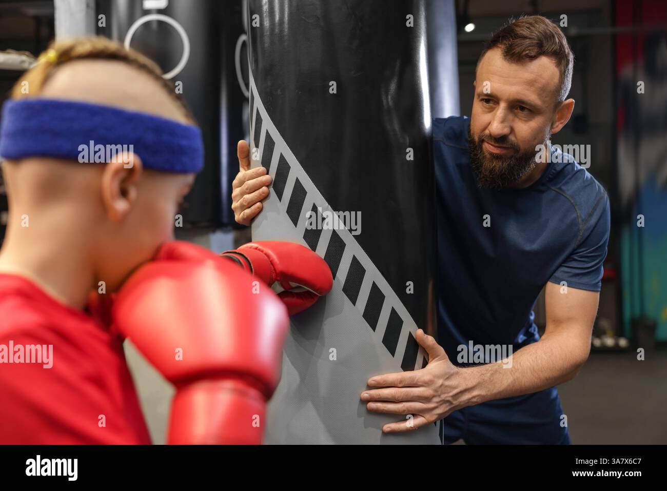Boxing coach training boy in sport center Stock Photo - Alamy
