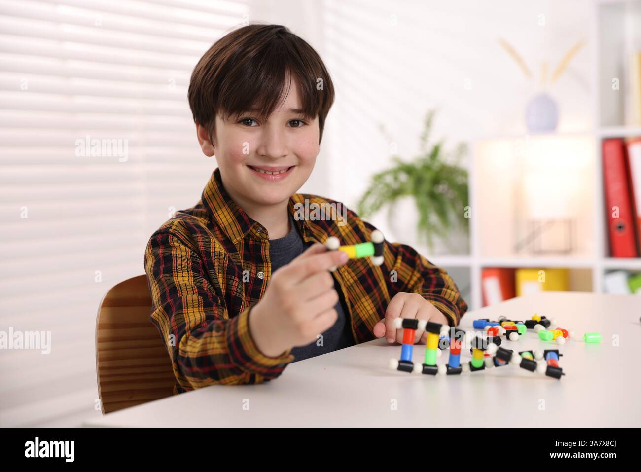 Boy making DNA structure model at desk indoors Stock Photo - Alamy