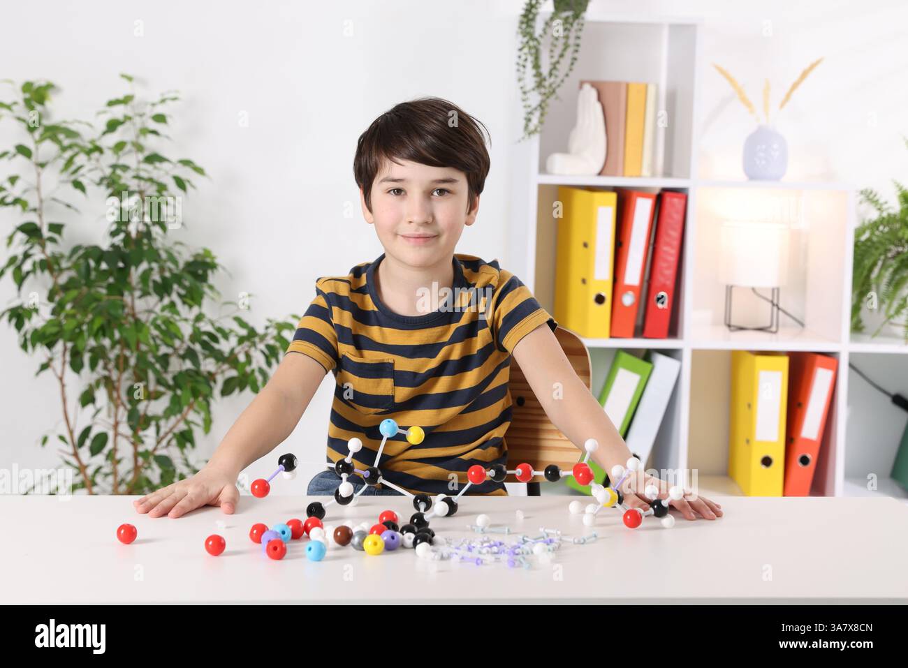 Boy with DNA structure model at desk indoors Stock Photo - Alamy