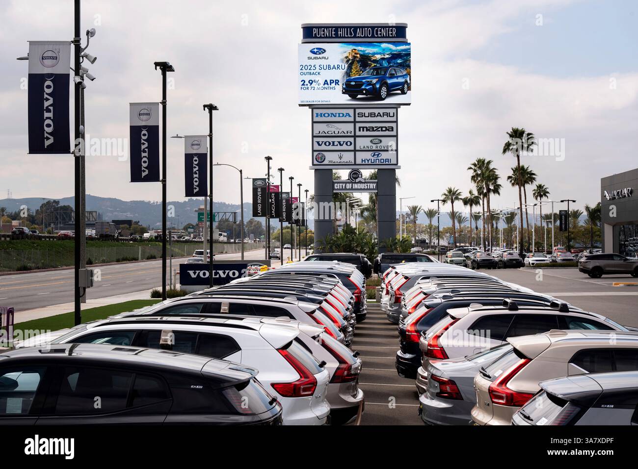 Signs for import car brands are seen at an auto mall in the City of ...