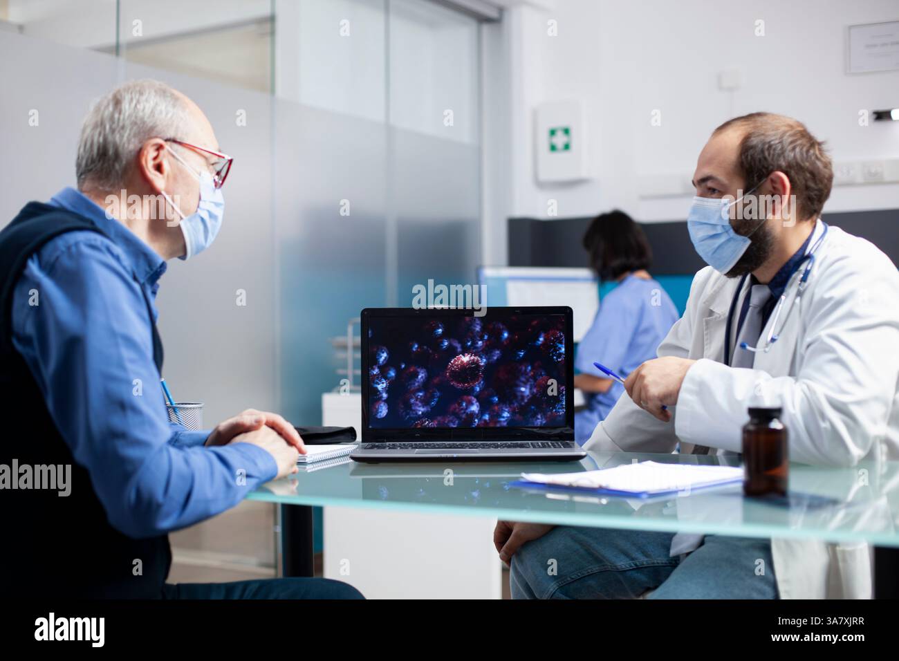 Physician explains sickness prevention to senior man, pointing to ...