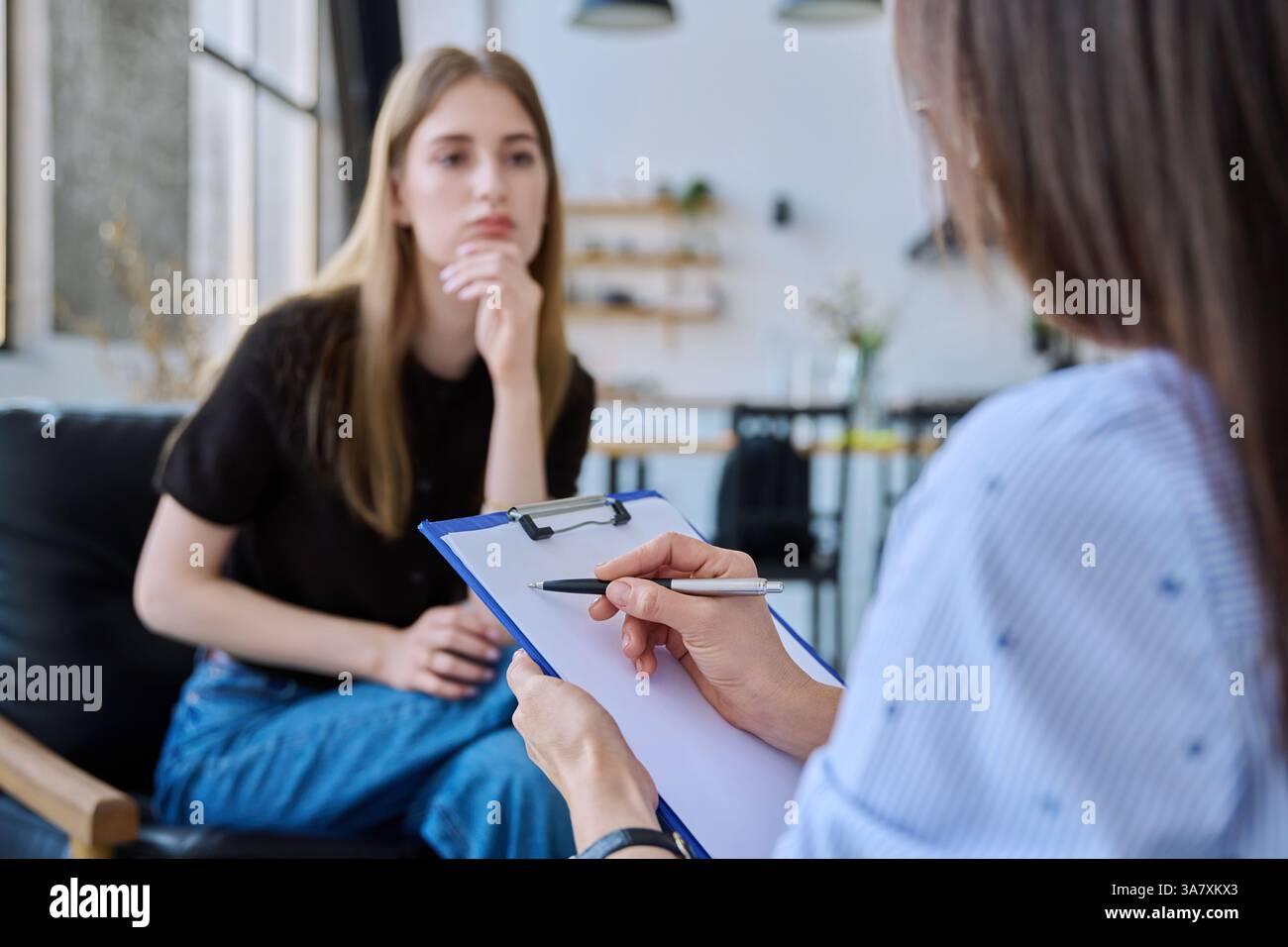 Focus on clipboard in hands of working mental health specialist ...