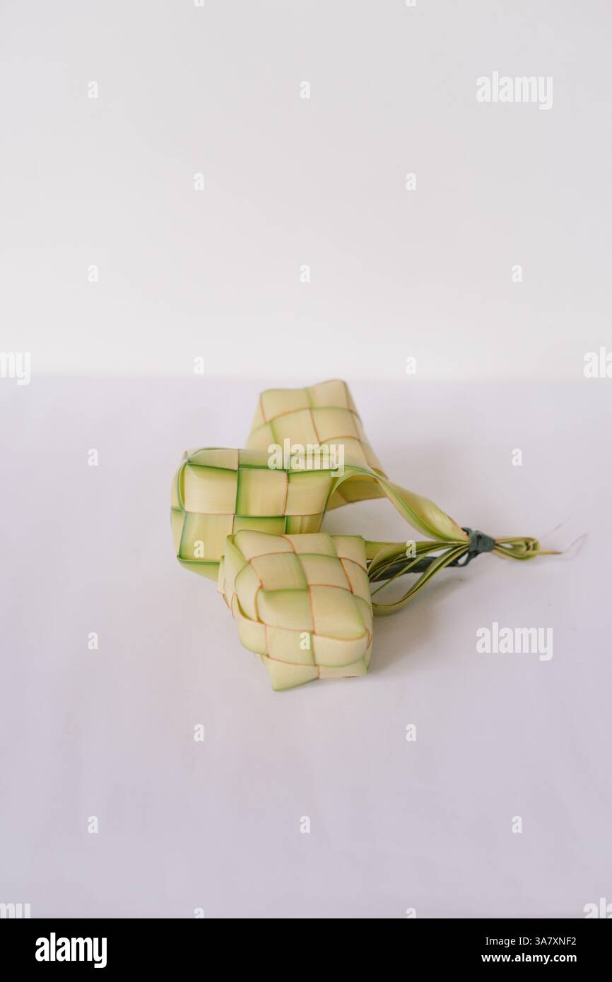 Ketupat, a traditional Southeast Asian rice dumpling, displayed against ...