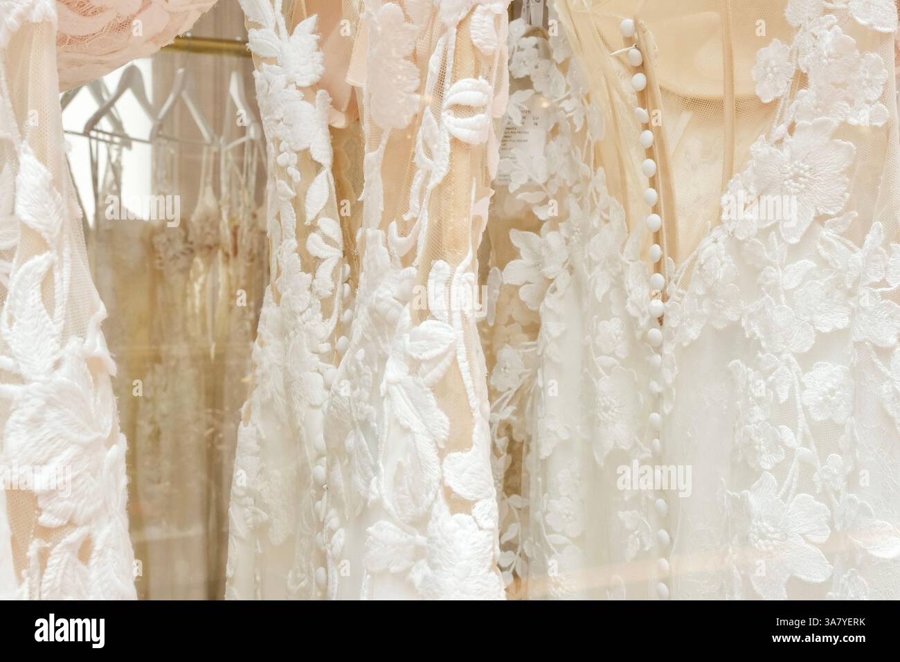 Close-up of lace, sheer fabric and silk chiffon wedding dresses on ...