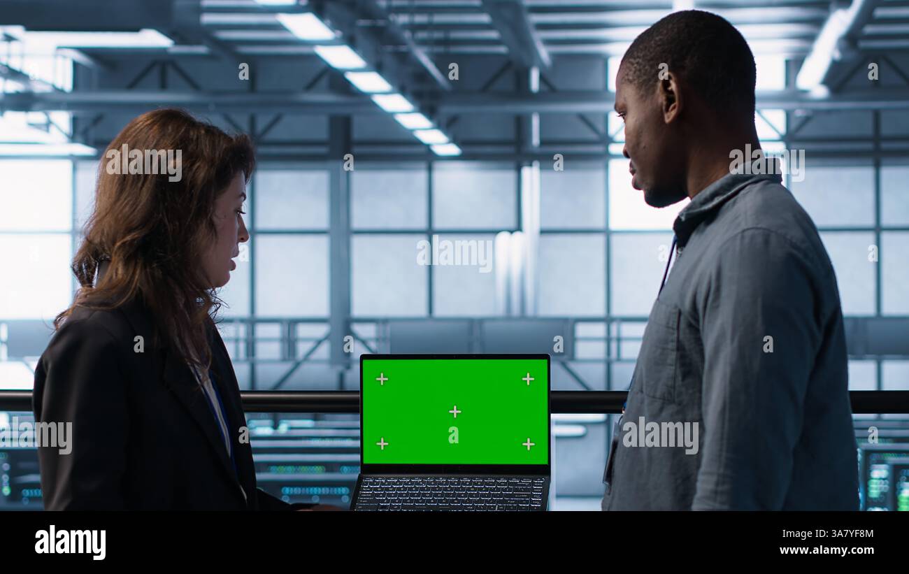 Data Center Team Of Computer Scientists Using Mockup Laptop To Review