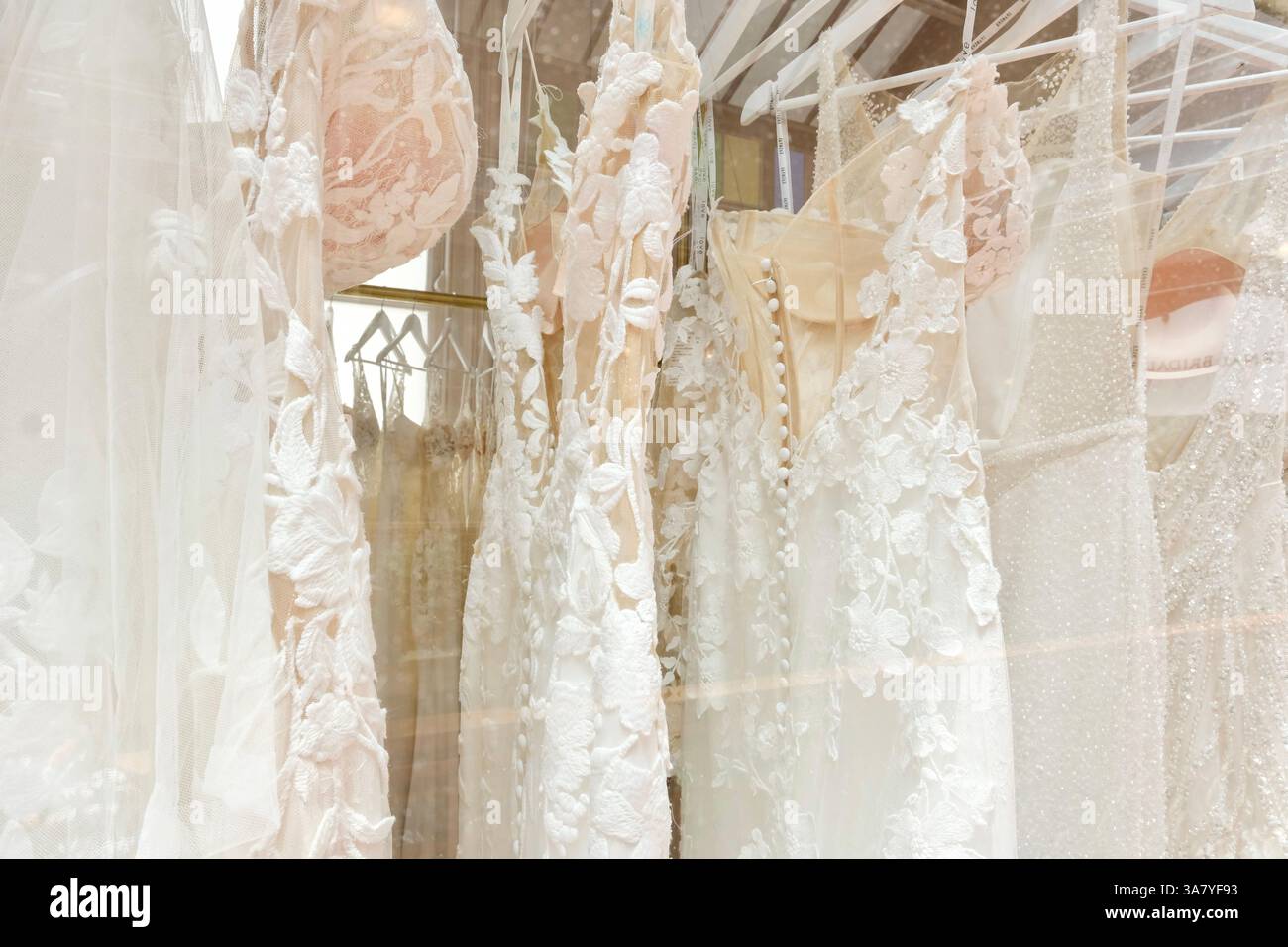 Close-up of lace, sheer fabric and silk chiffon wedding dresses on ...