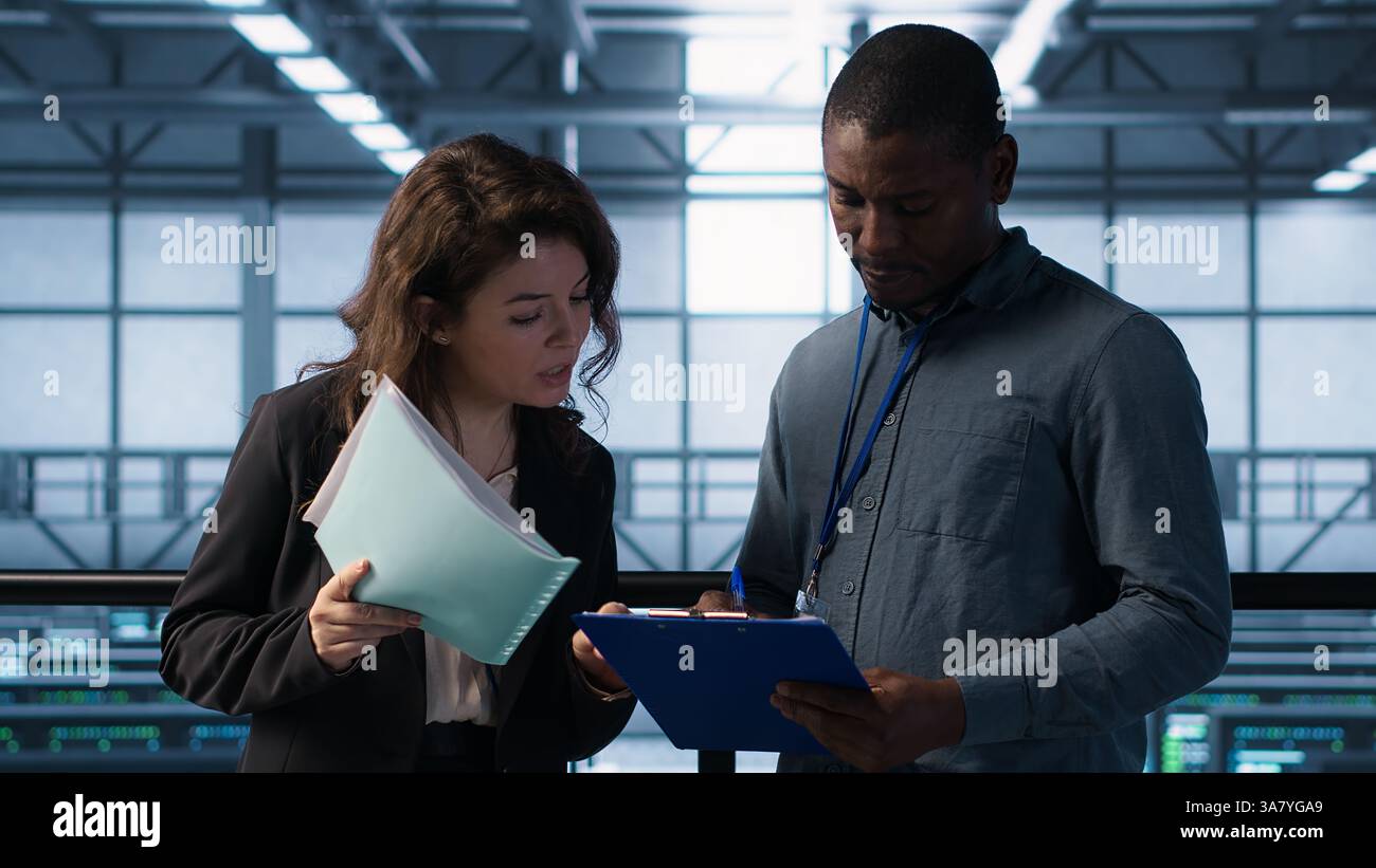 Data center management executives reading paperwork files, reviewing ...