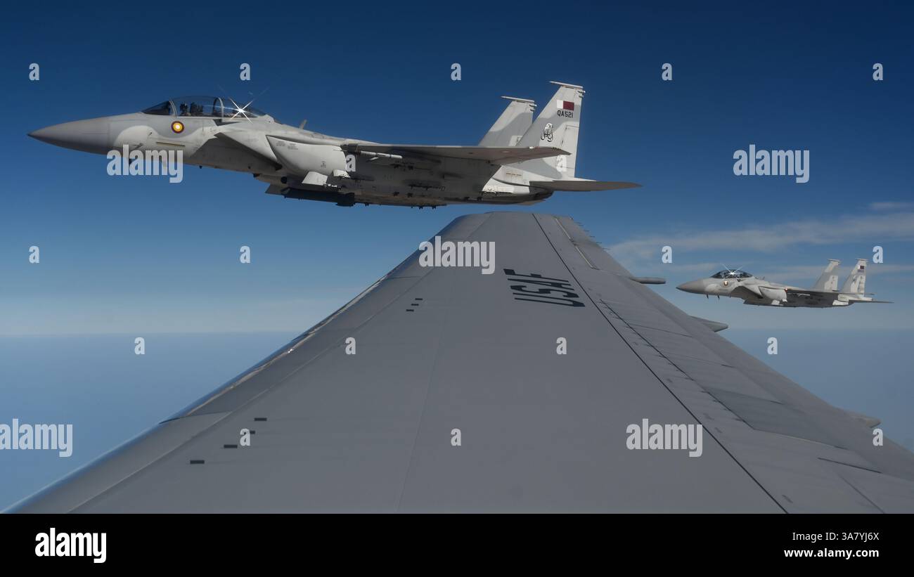 Two Qatar Emiri Air Force F-15QA Ababil fly in formation with a U.S ...