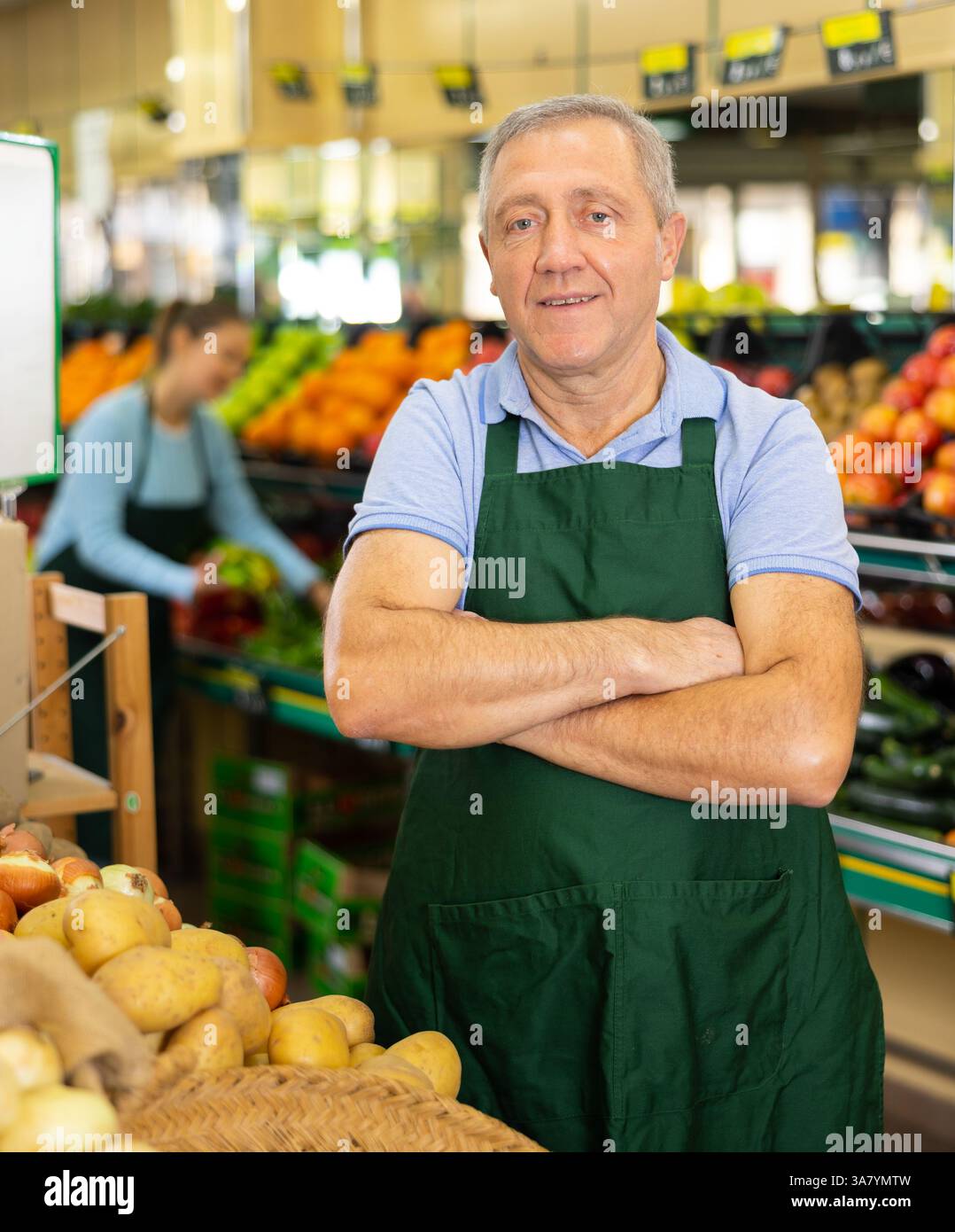 vegetable salesman in supermarket Stock Photo - Alamy