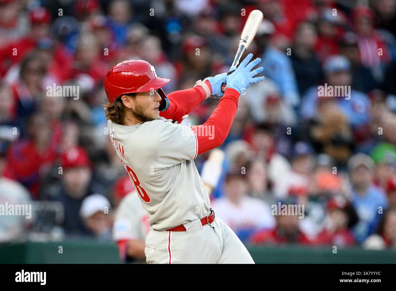 Philadelphia Phillies' Alec Bohm follows through on his 2 RBI double in the 10th inning of an ...
