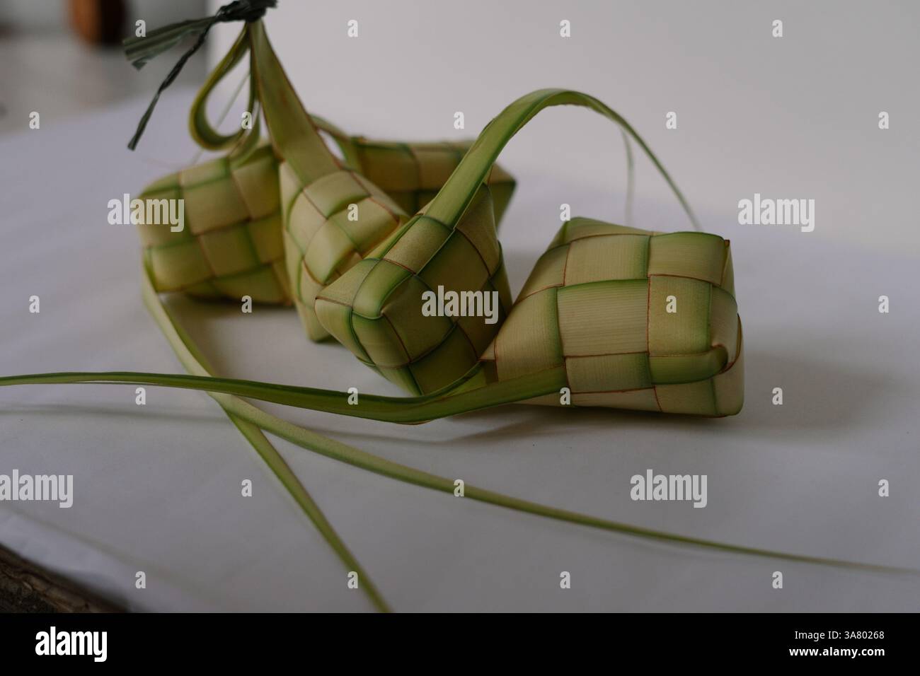 Close-up of ketupat, a diamond-shaped rice cake wrapped in woven young ...