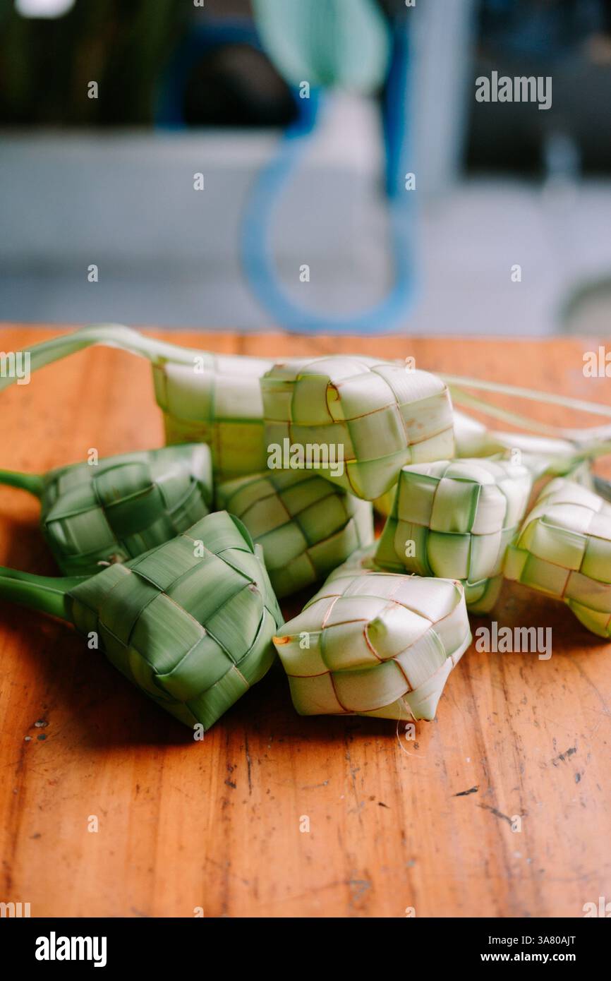 A close-up studio shot showcases a pile of ketupat, traditional rice ...
