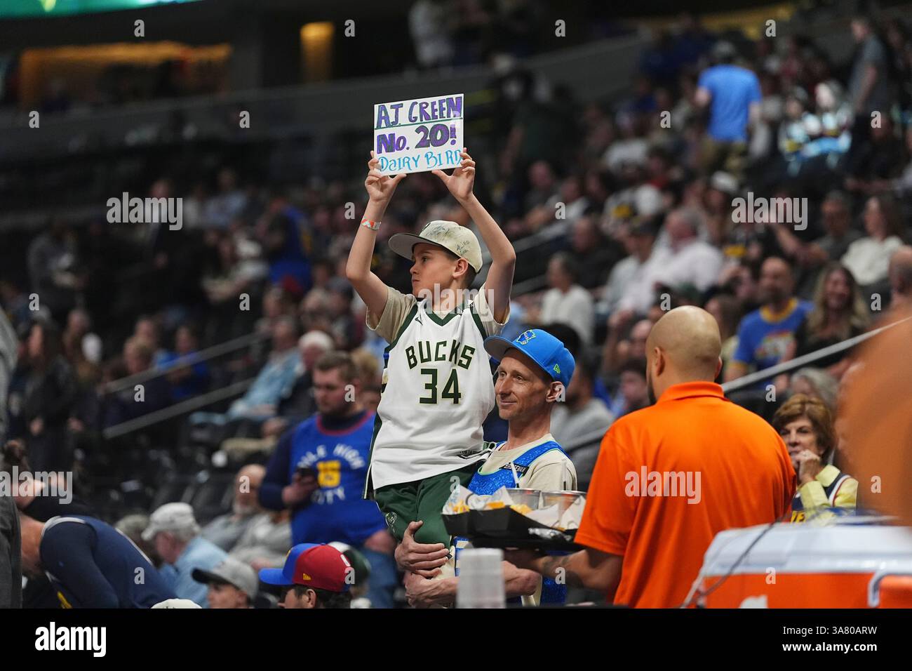 A Milwaukee Bucks fan holds up a placard in support of guard AJ Green ...