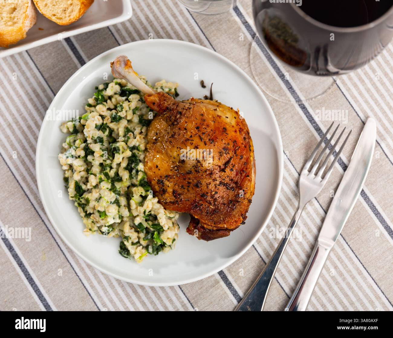 Roasted to crispy dark crust, duck leg is garnished with boiled pearl ...