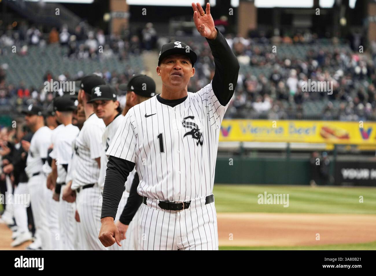 Chicago White Sox manager Will Venable, left, waves to fans as he walks ...