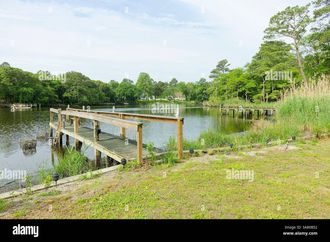 A pier stretches over a finger of the Delaware Bay in a rural ...