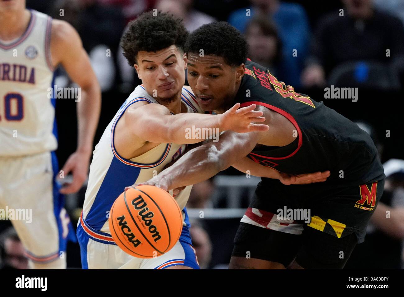 Florida guard Walter Clayton Jr. (1) and Maryland guard Rodney Rice (1 ...