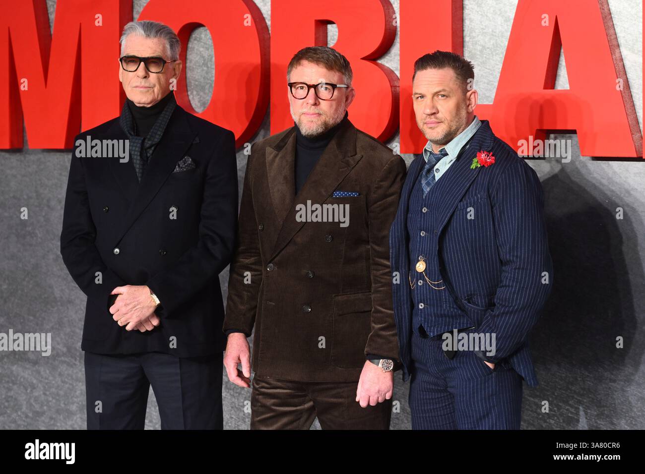 London, UK. 27 March 2025. Tom Hardy, Guy Ritchie, and Pierce Brosnan ...