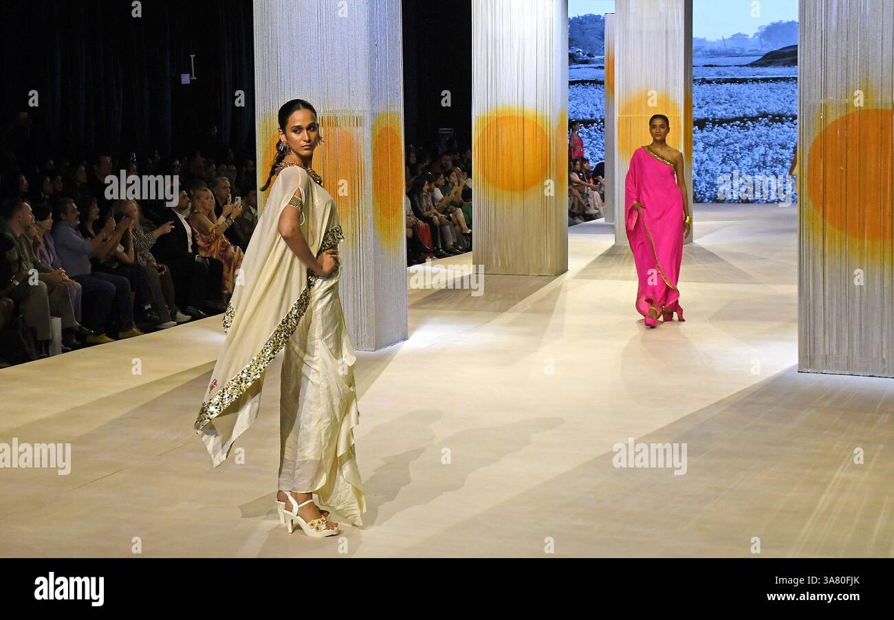 Mumbai, India. 27th Mar, 2025. Models showcase creation by designer ...