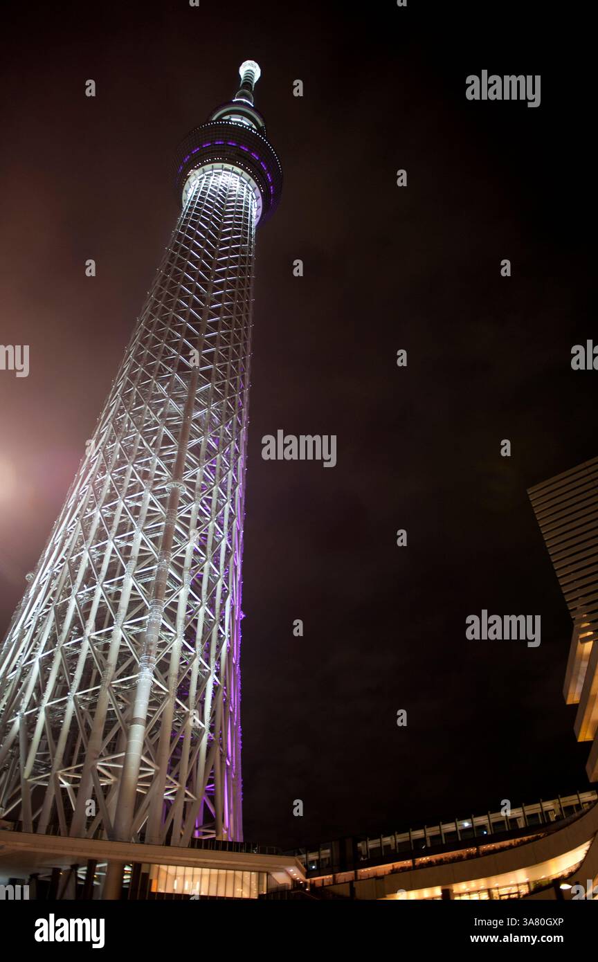 Close-up foggy nighttime view looking skyward of the iconic illuminated ...