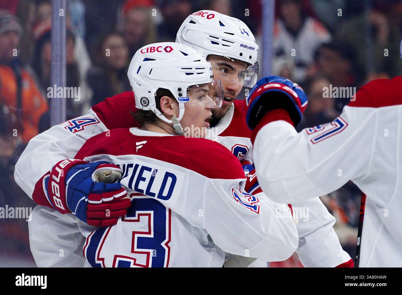Montreal Canadiens' Cole Caufield (13) celebrates his goal with Nick ...