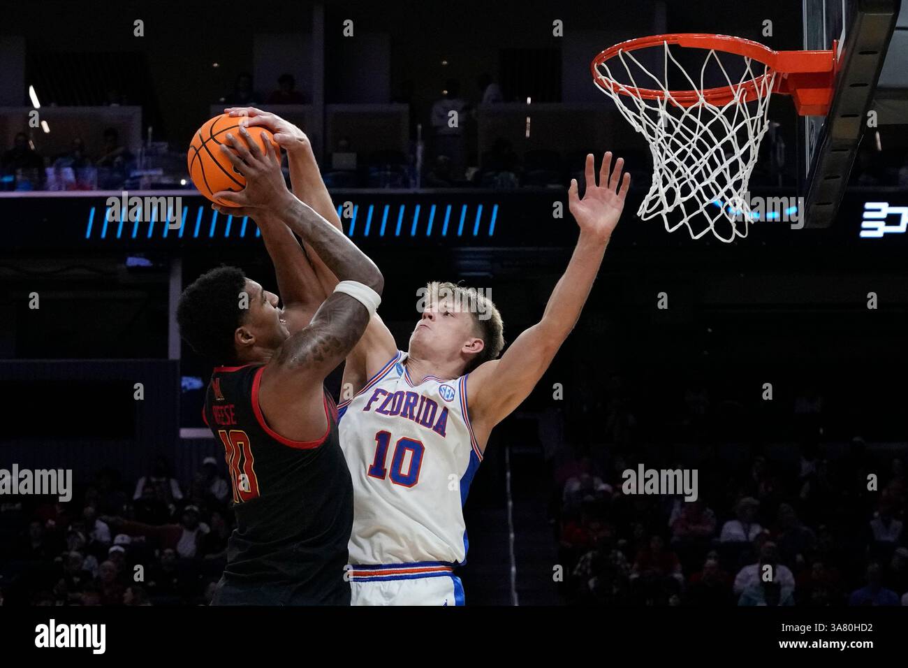 Florida forward Thomas Haugh, right, blocks a shot by Maryland forward ...