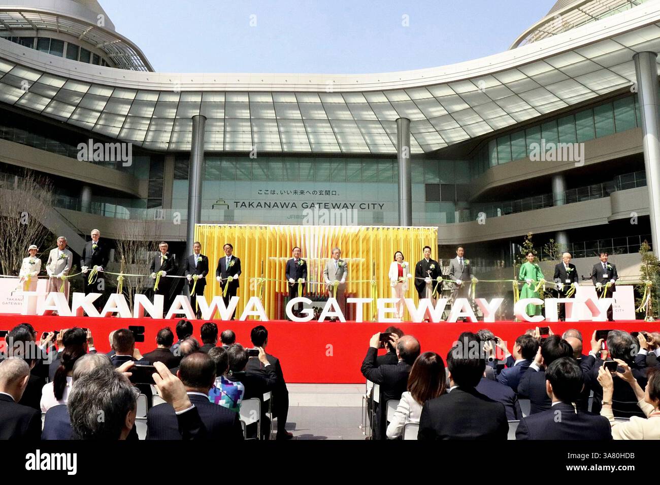 People involved celebrate the opening of Takanawa Gateway City in ...