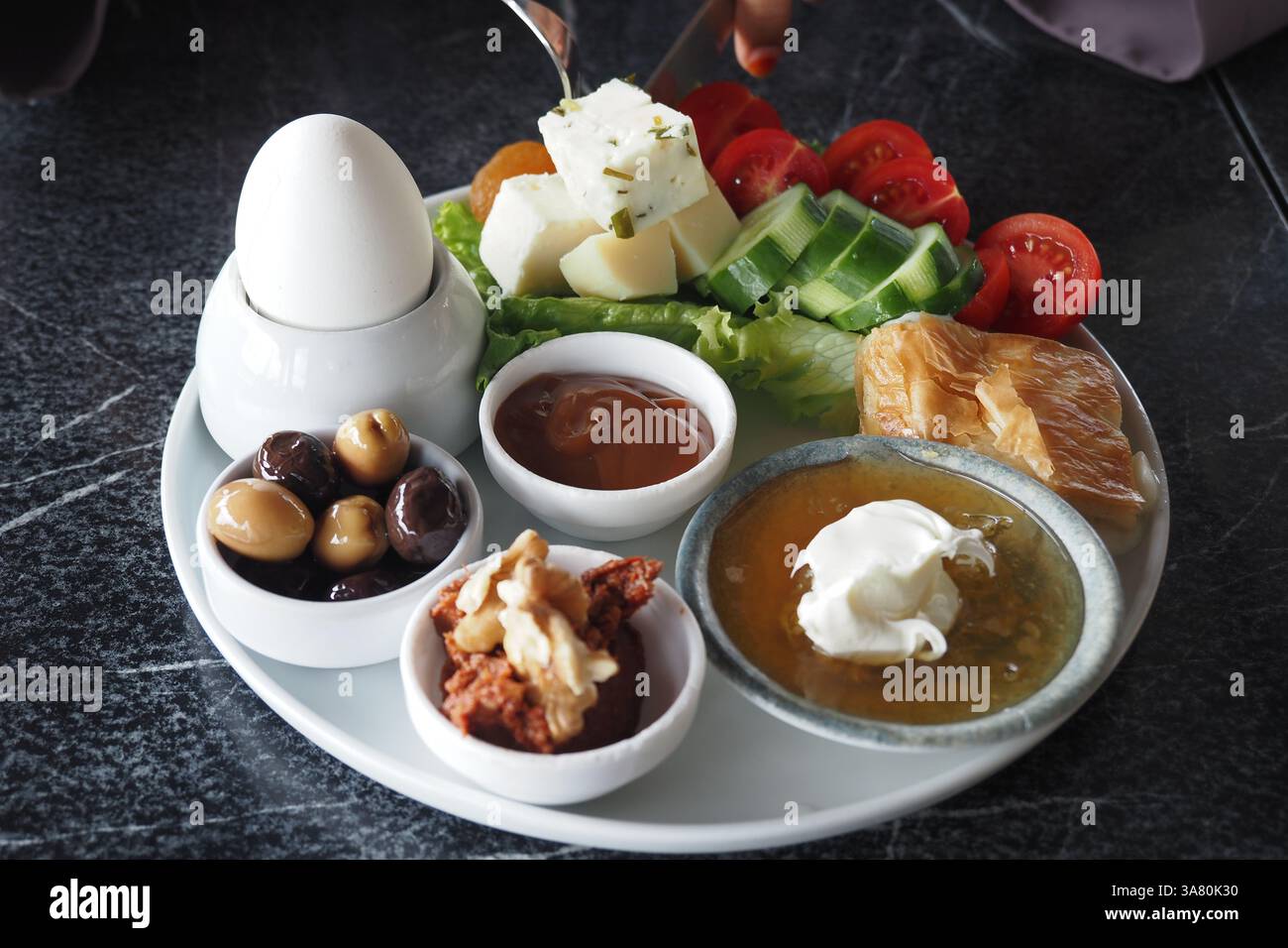 turkish breakfast spread features vegetables, cheese, and olives on a ...