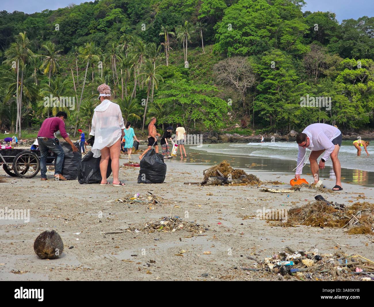 Koh Kood, Thailand, 13 March 2025, Volunteers gather along the sandy ...