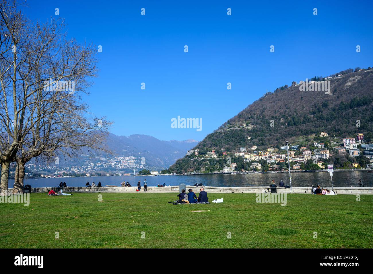 People relaxing in a park by Lake Como – Como, Italy – 05 March 2025 ...