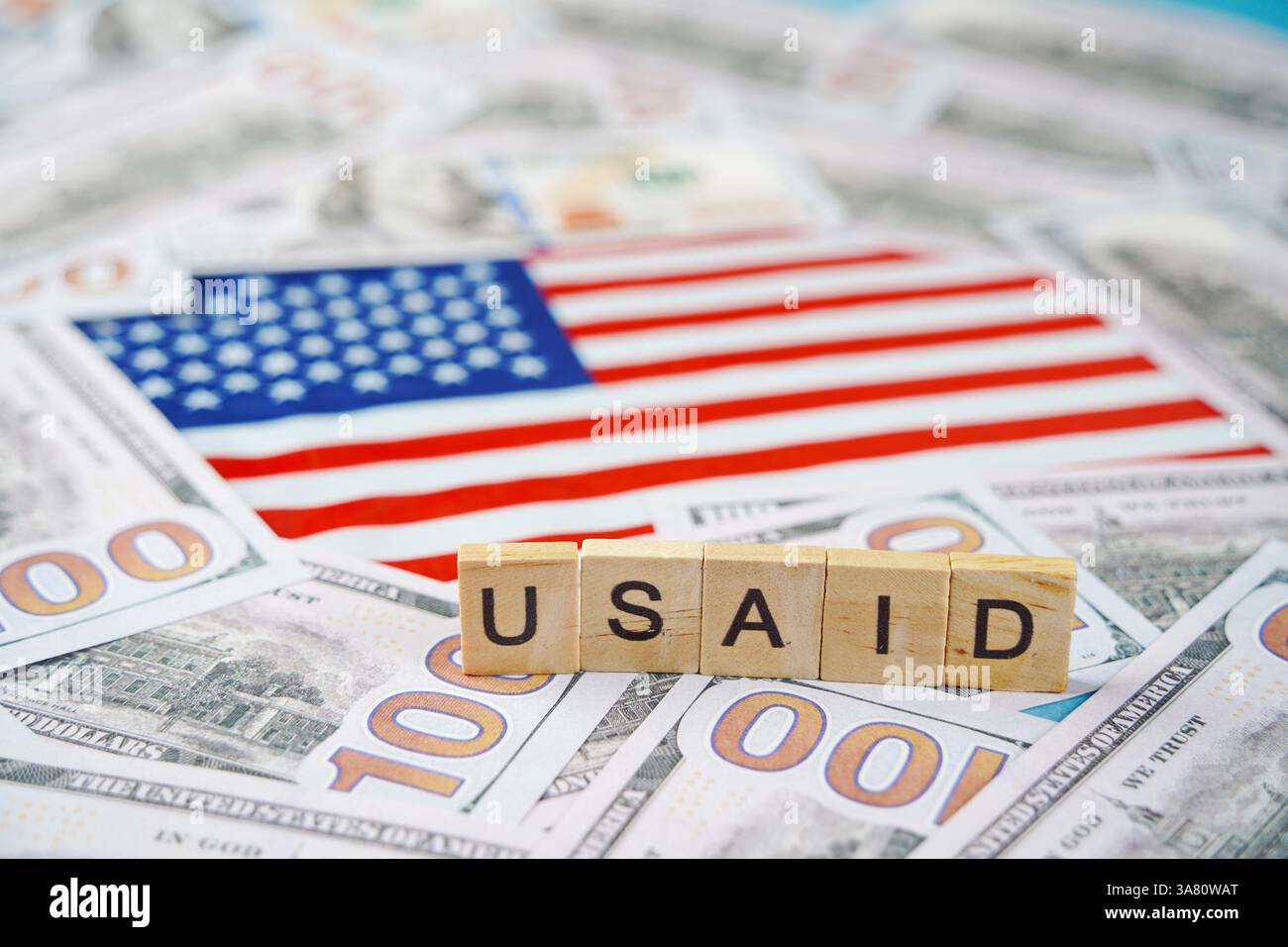 The USAID inscription on the background of the US flag and dollar bills ...