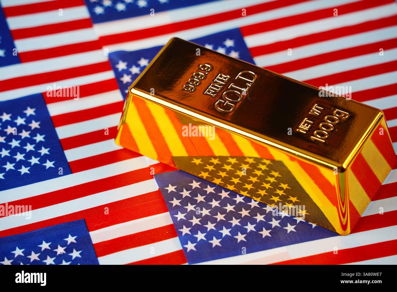 A gold bar on the background of the flags of the USA. Gold and foreign ...