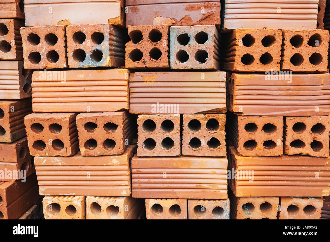 stack of hollow red bricks on a construction site Stock Photo - Alamy