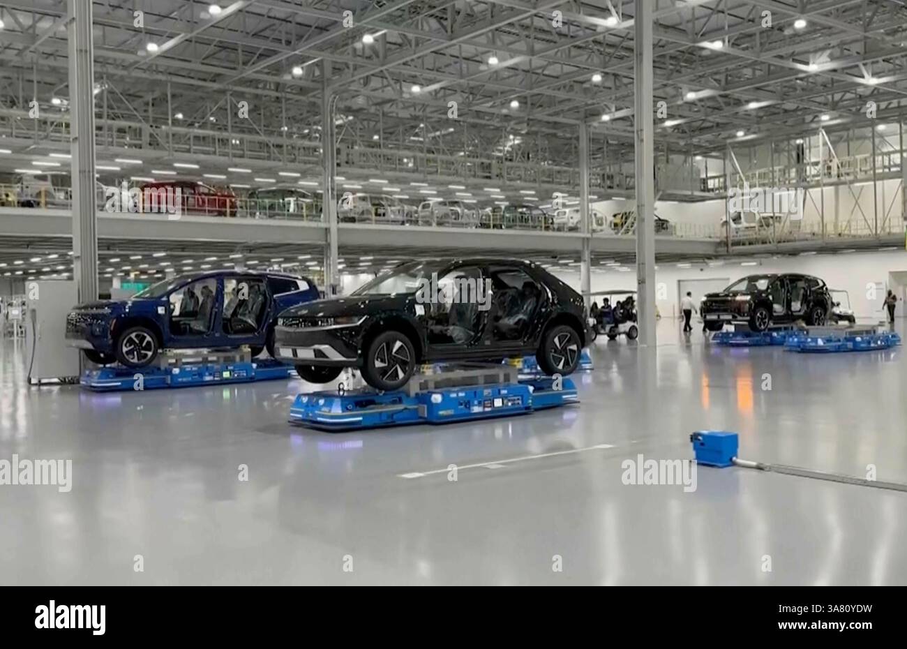 In this image taken from video, electric cars are assembled at a new ...