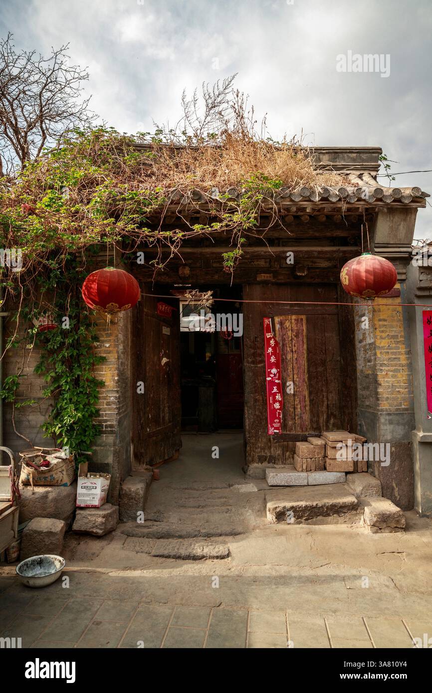 Chinese Entrance with Stone Columns and Wooden Door Stock Photo - Alamy