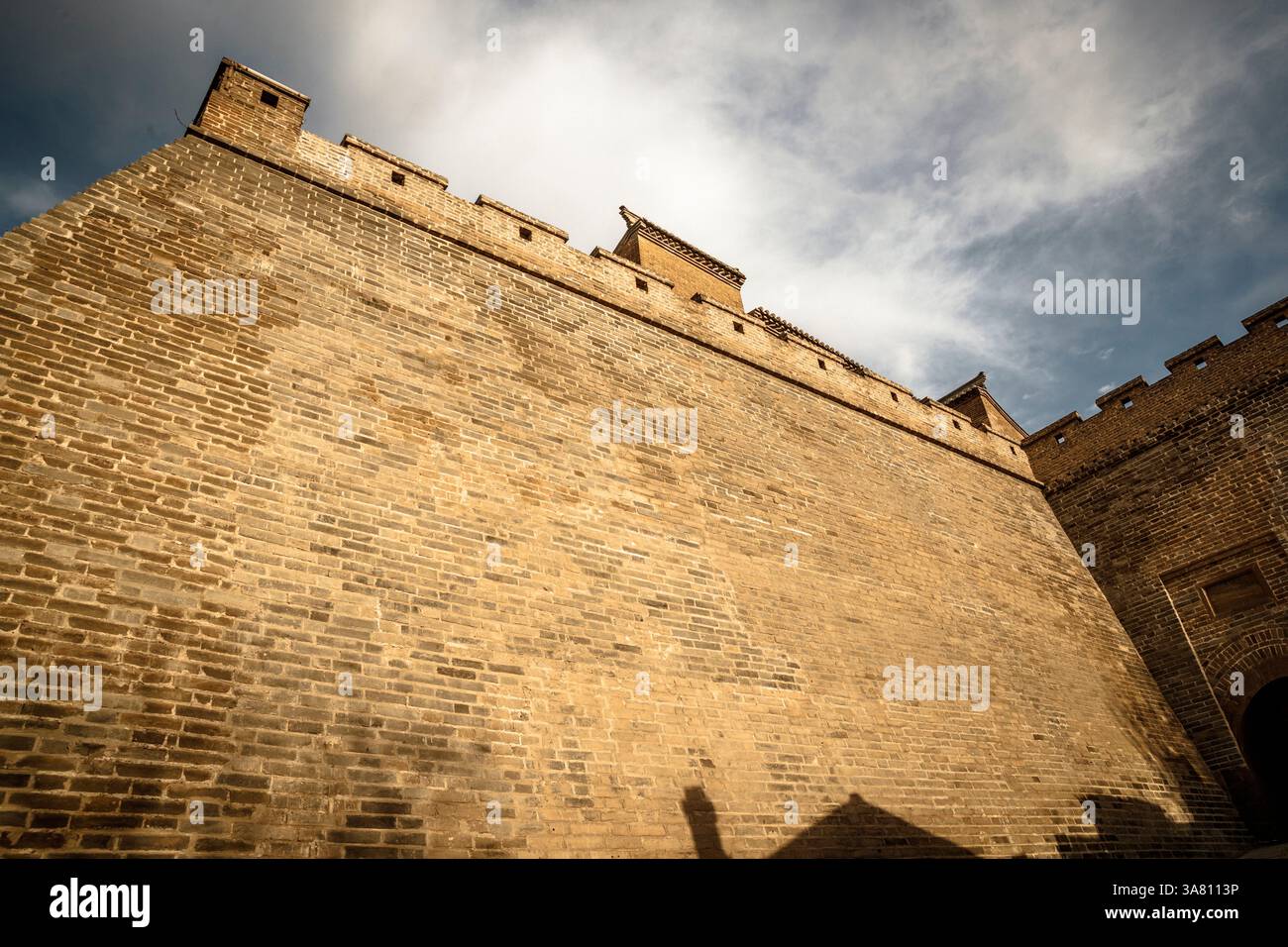 Traditional Chinese City Wall Entrance Under Cloudy Sky Stock Photo - Alamy