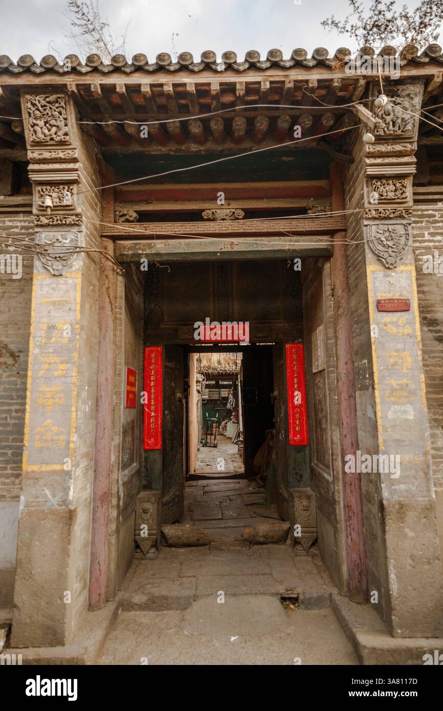 Chinese Entrance with Stone Columns and Wooden Door Stock Photo - Alamy