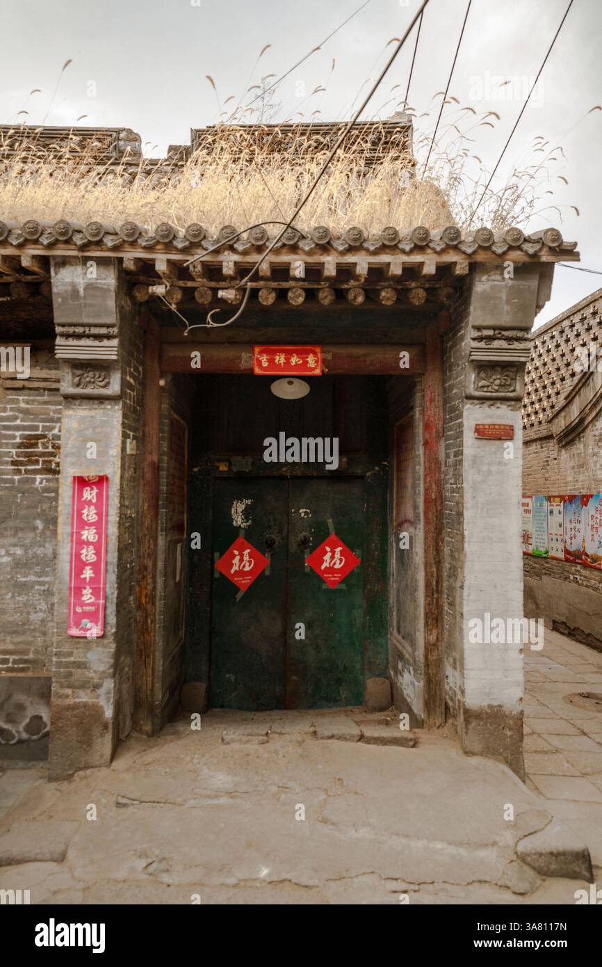 Chinese Entrance with Stone Columns and Wooden Door Stock Photo - Alamy