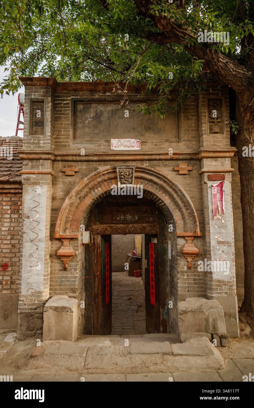 Chinese Entrance with Stone Columns and Wooden Door Stock Photo - Alamy