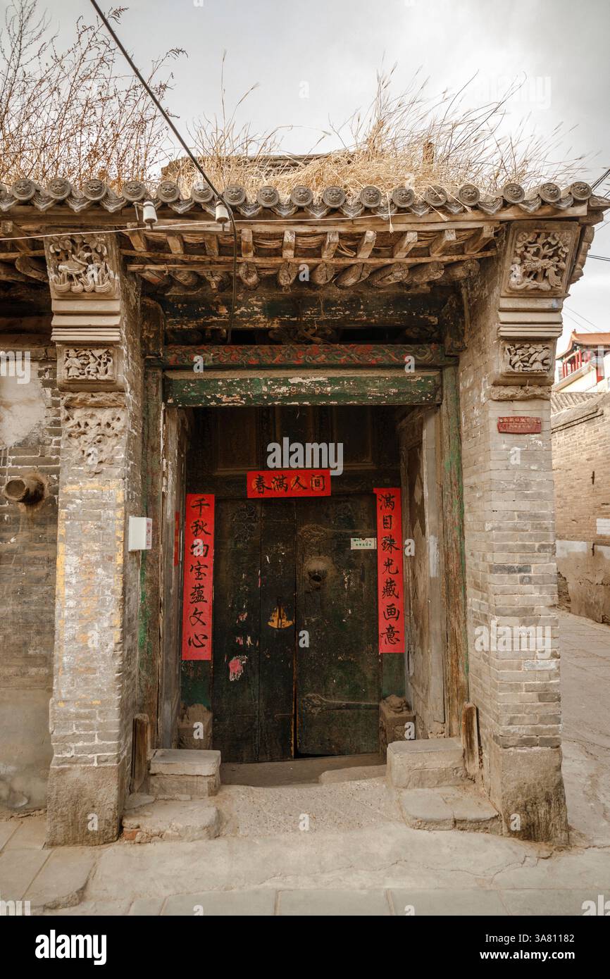 Chinese Entrance with Stone Columns and Wooden Door Stock Photo - Alamy