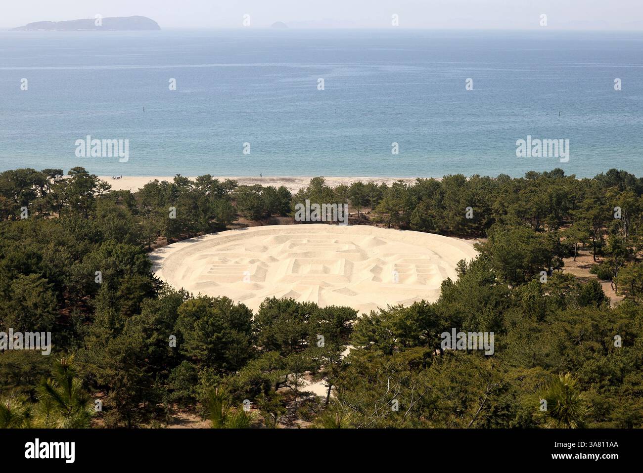 A photo shows "Zenigata Sand Art," a giant sand painting in the shape ...