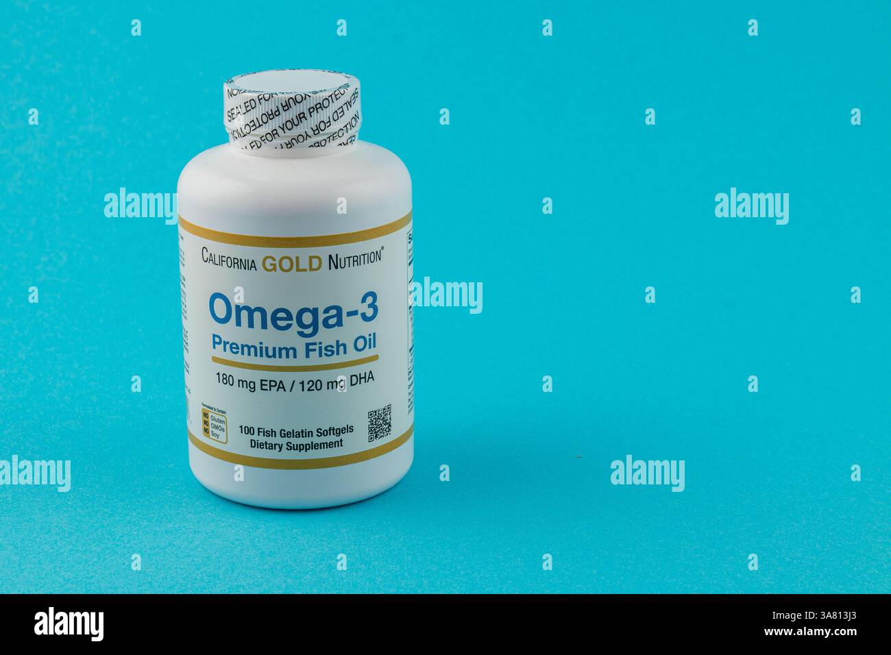 24.03.25 Lviv Ukraine A bottle of omega 3 premium fish oil is showcased on a vibrant blue ...