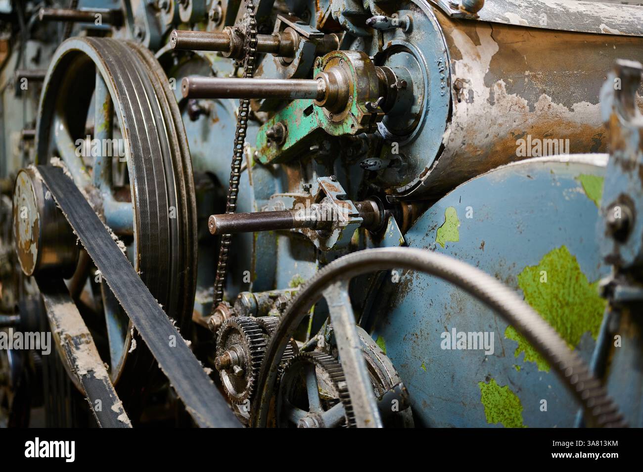 Intricate mechanisms at play in a vintage industrial machine surrounded ...