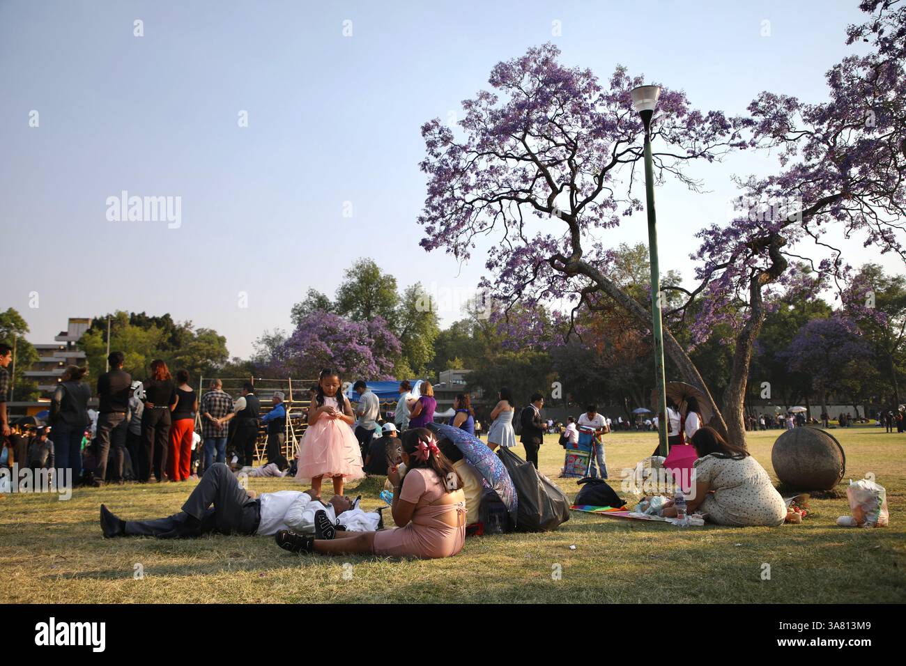 Relatives attend a graduation ceremony in a park on the UNAM university ...
