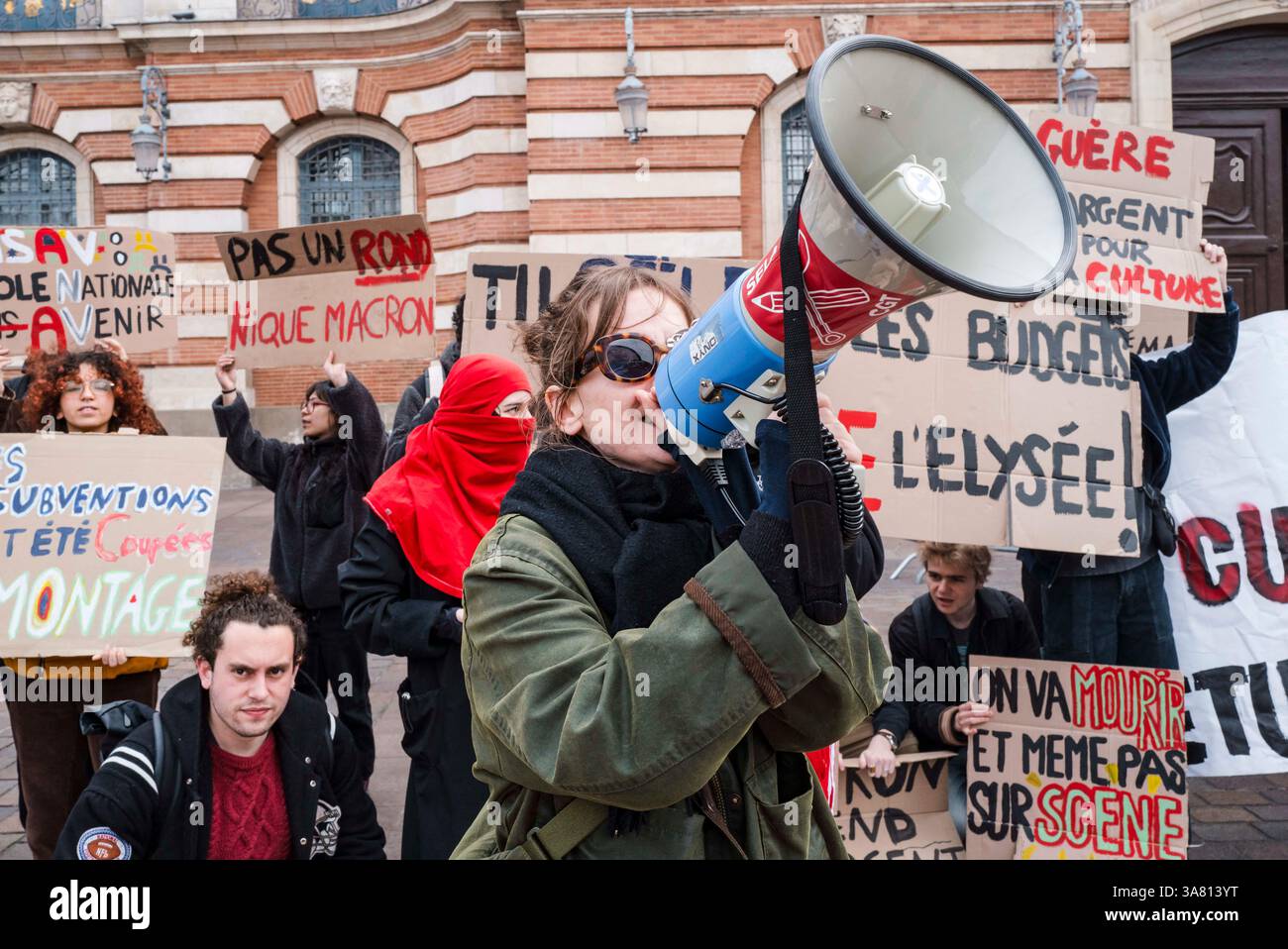 A demonstrator with a megaphone in front of the capitol. Demonstrators ...